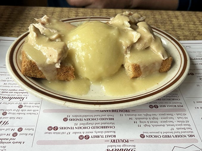 The open-faced hot turkey sandwich—where bread becomes a throne for turkey royalty, all gloriously drowning in gravy that should be classified as a controlled substance.