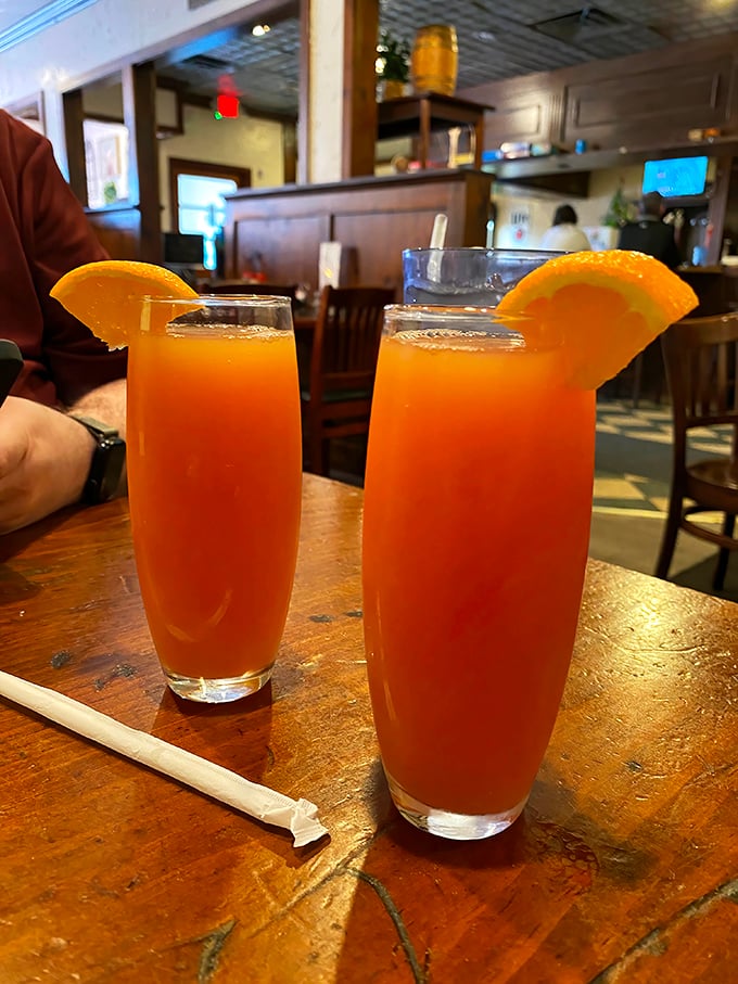 Fresh-squeezed orange juice served in proper glasses with actual orange slices—because sometimes the simplest pleasures are the most impressive.