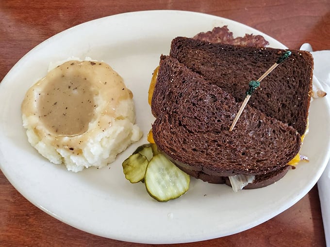The patty melt and mashed potatoes—a partnership more iconic than Batman and Robin. The gravy pool is basically a superhero cape in liquid form.