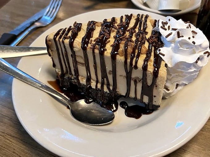 A slice of peanut butter pie that makes grown adults fight over the last bite. Chocolate drizzle creates edible art that's too delicious to Instagram before devouring.