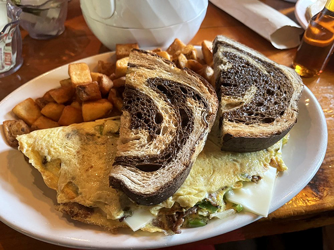 This isn't just an omelet—it's a masterclass in breakfast engineering. Marbled rye toast adds the perfect supporting character to this morning blockbuster.