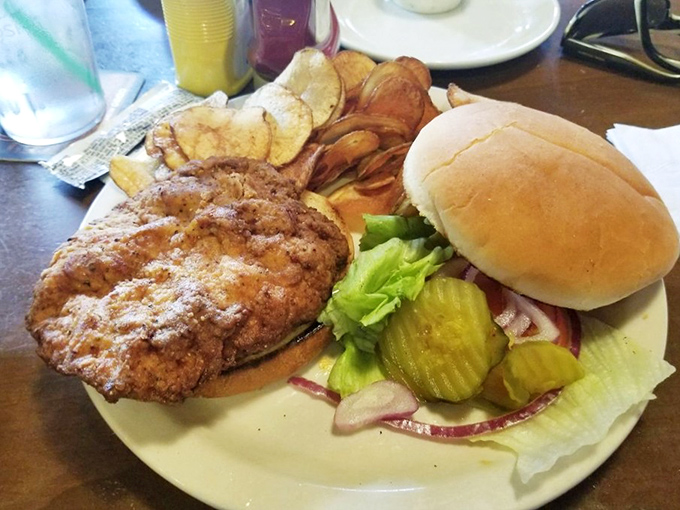 The pork tenderloin sandwich – a Midwestern monument to the beautiful art of taking something simple and making it gloriously excessive.