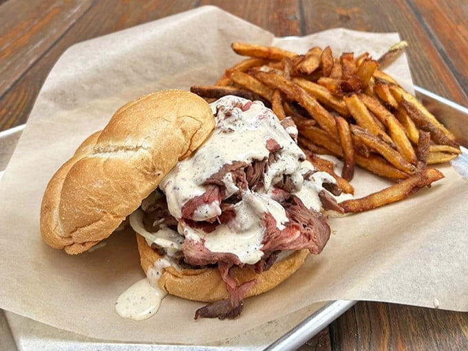 The pulled pork sandwich—where smoke meets soul. A testament to the fact that sometimes the simplest presentations deliver the most profound flavors.