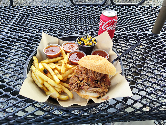 The pulled pork sandwich in its natural habitat—surrounded by sauce options and waiting to change someone's life forever. Resistance is futile.
