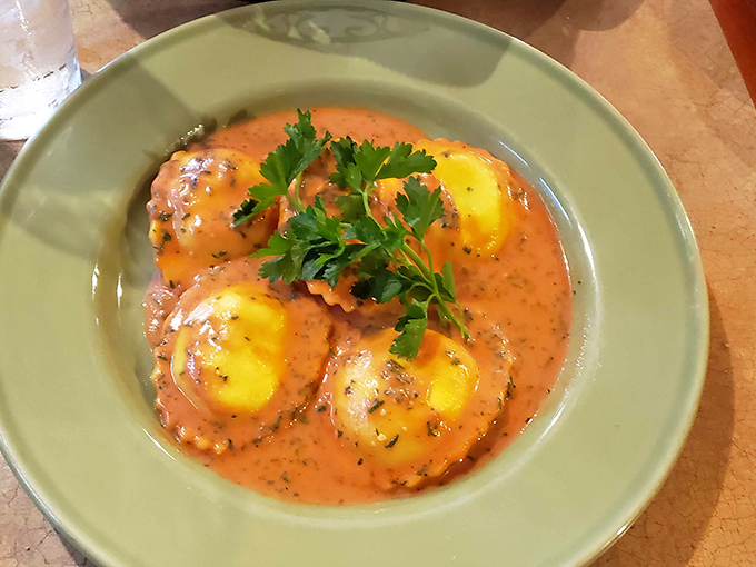 These ravioli aren't just swimming in sauce—they're doing the backstroke in flavor heaven. Pillowy pasta islands in a sea of rich, herb-flecked tomato bliss. 