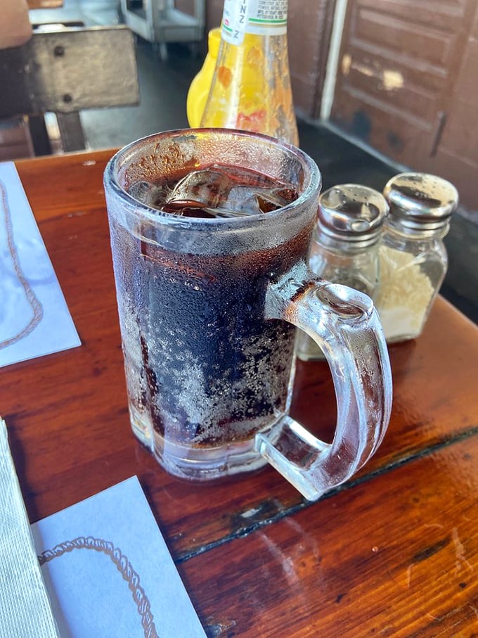 A frosty mug of root beer—the perfect counterpoint to all that smoky goodness. It's like the universe created carbonation specifically for this moment.