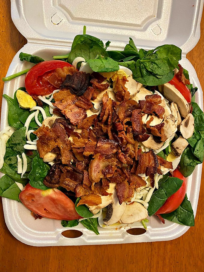 Spinach salad that even Popeye would approve of. The bacon bits aren't just toppings—they're little flavor bombs of pure joy.