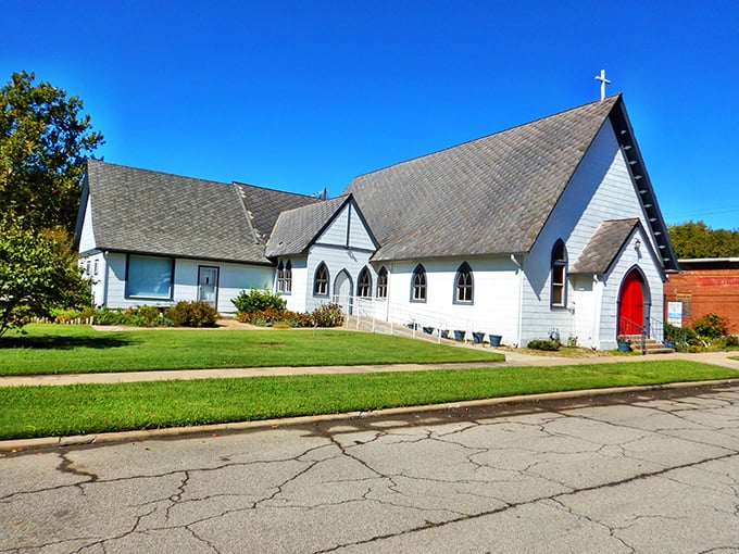 This charming white church with its vibrant red door stands as a testament to faith, community, and architectural simplicity in small-town America.