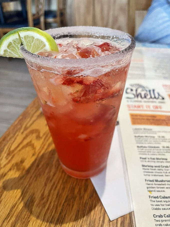A ruby-red cocktail with a salt-rimmed edge and lime garnish—Florida's liquid sunshine in a glass. The perfect companion for seafood indulgence.
