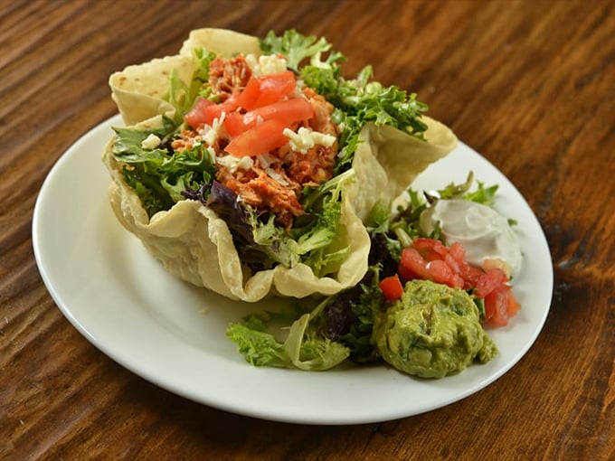 This taco salad isn't just breaking free from its shell—it's having a full-blown liberation celebration with fresh greens and seasoned protein.
