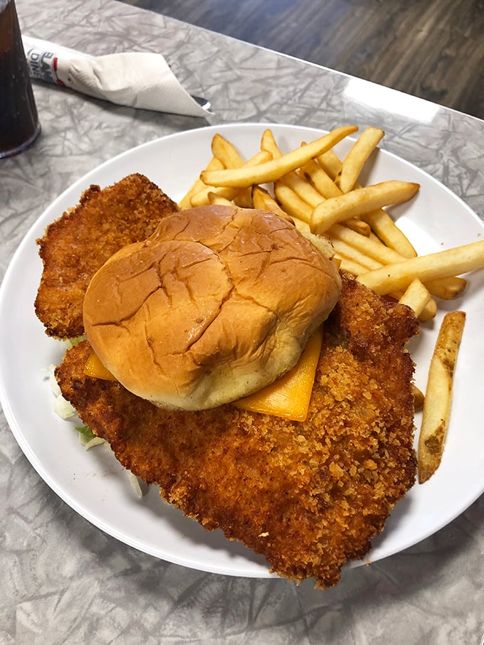 The breaded tenderloin sandwich – where the meat extends far beyond the bun's jurisdiction in that gloriously Midwestern way we've come to cherish.