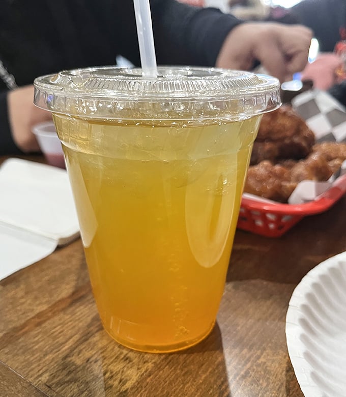 That golden elixir isn't just a beverage – it's the perfect tropical counterpoint to cut through the richness of perfectly fried chicken.