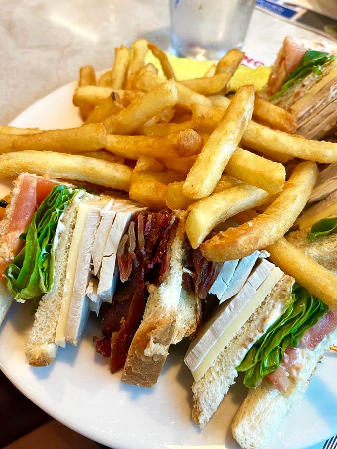 The club sandwich – that architectural marvel of diner cuisine. Layers of turkey, bacon, and fresh greens perfectly stacked between toasted bread triangles. A skyscraper of satisfaction.
