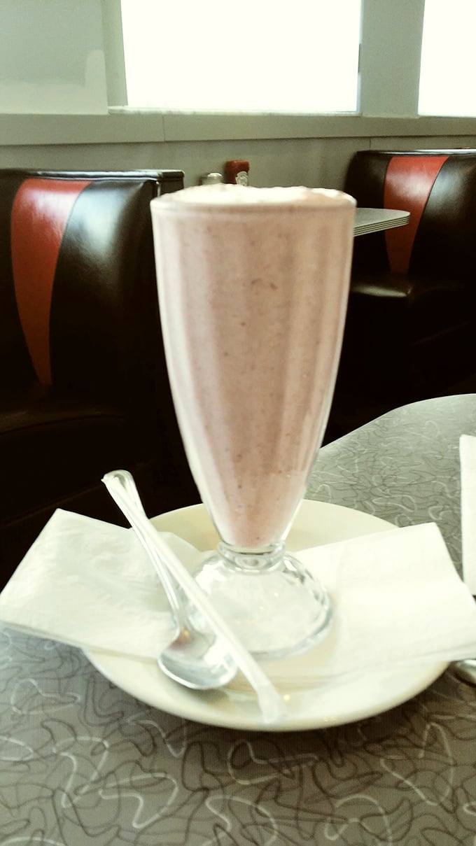 This vanilla milkshake isn't just a drink – it's a towering achievement of creamy nostalgia served in a glass tall enough to have its own zip code.