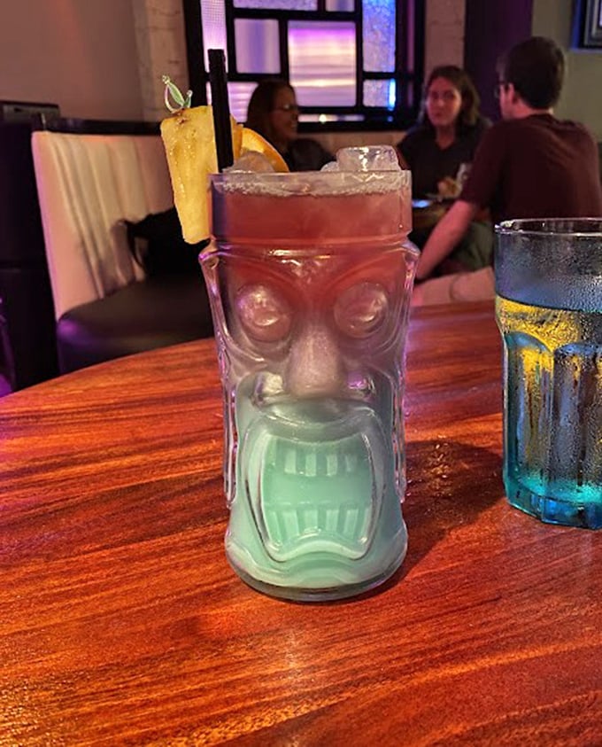 Not just a cocktail, but a conversation piece. This tiki-inspired creation comes in a glass that looks like it might judge your drink choices.