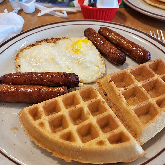 Waffles with perfect grid patterns that practically beg for maple syrup to fill those little squares. Paired with eggs and sausage, it's breakfast harmony on a plate.