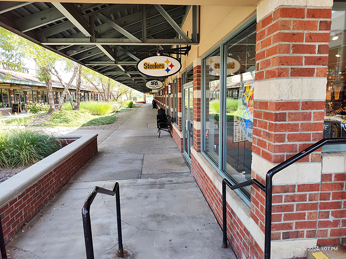 The walkway's architectural details and landscaping transform what could be a utilitarian shopping experience into something that feels almost like a retail park.