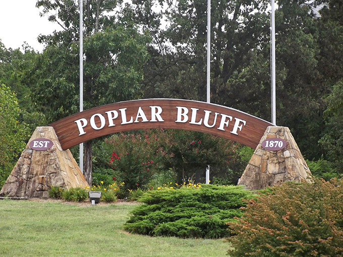 "EST 1870" – Poplar Bluff's welcome sign anchored by natural stone pillars greets visitors with Midwestern warmth and historical pride.