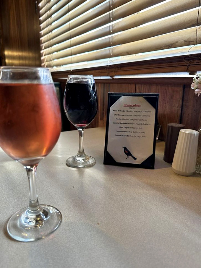 Wine glasses catching the light like liquid jewels – proof that even in hunting lodge surroundings, civilized pleasures aren't forgotten.