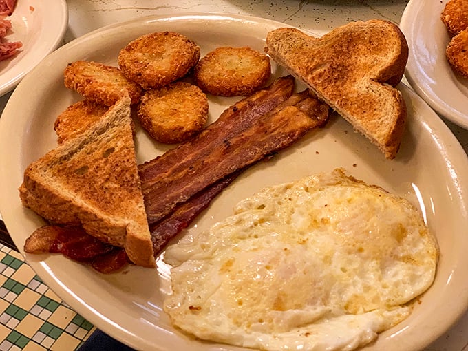 The breakfast trinity – perfectly cooked eggs, crispy bacon, and golden hash browns – simple perfection that needs no fancy culinary terminology.