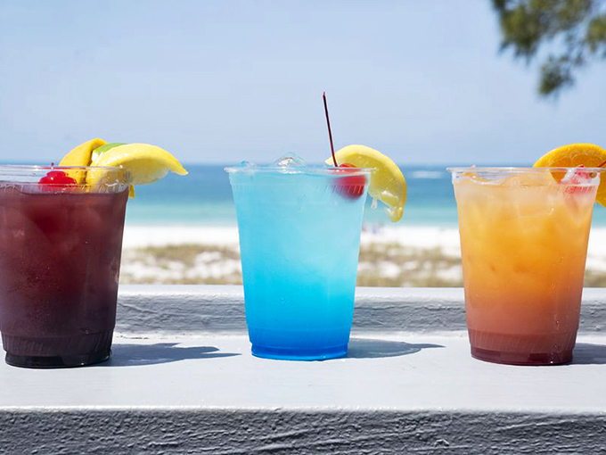 Beach cocktails that taste like vacation in a plastic cup – the holy trinity of rum, fruit juice, and Florida sunshine.
