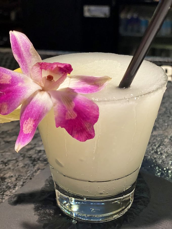 Not just a drink, but a vacation in a glass. That orchid garnish isn't showing off—it's celebrating what's in the cup.