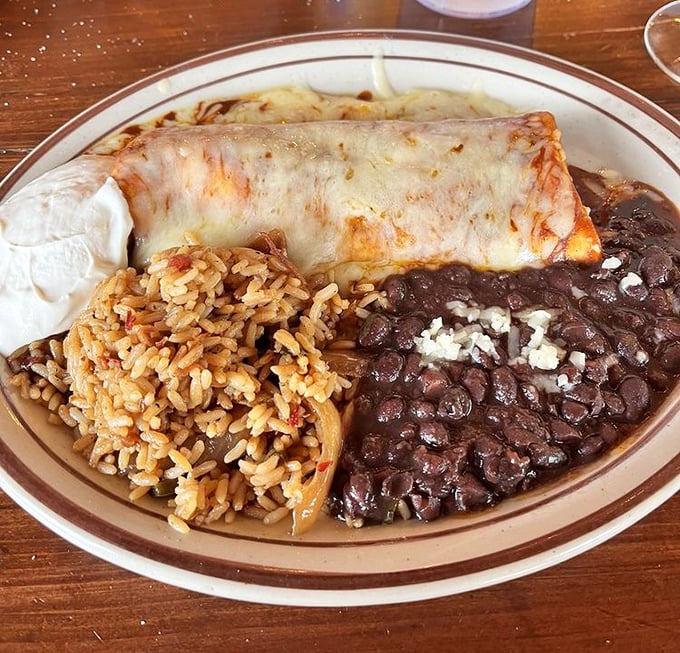 This isn't just a burrito – it's architecture. The melted cheese blanket tucked over beans and rice makes for comfort food that hugs you back.