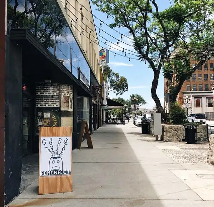String lights and sidewalk charm create Pomona's perfect urban oasis, where historic buildings house modern cafés perfect for post-antiquing refreshment.
