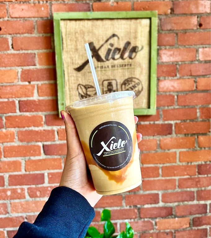 That caramel-swirled frappe isn't just a drink, it's a portable celebration with the Xielo logo as your invitation.