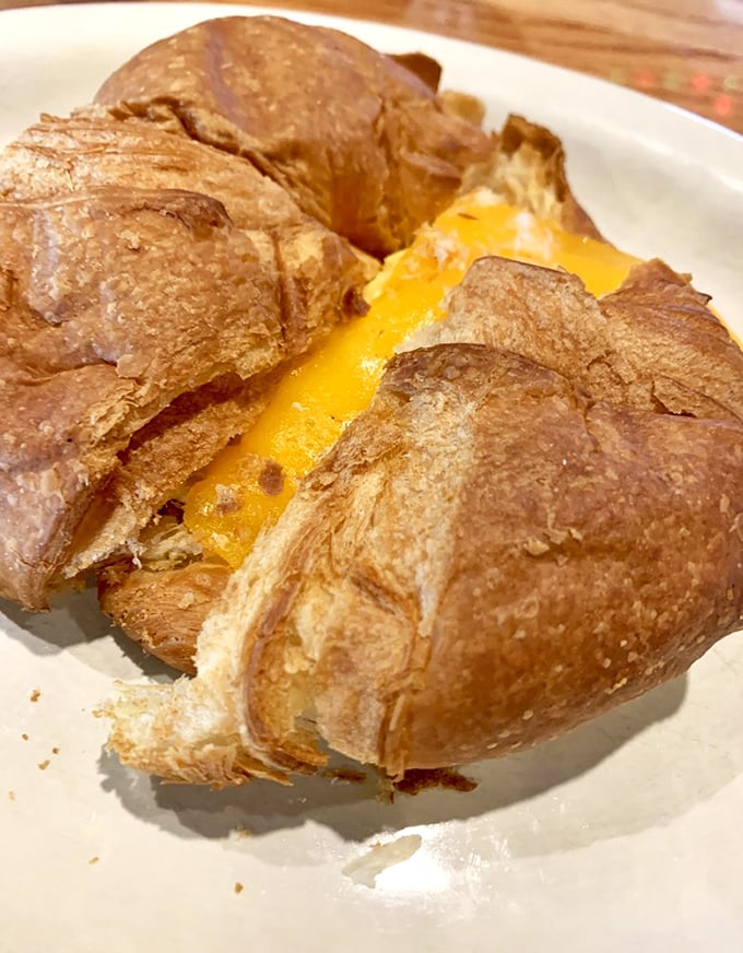 This croissant isn't just filled with cheese – it's experiencing a beautiful, melty transformation that would make any Parisian nod in approval.