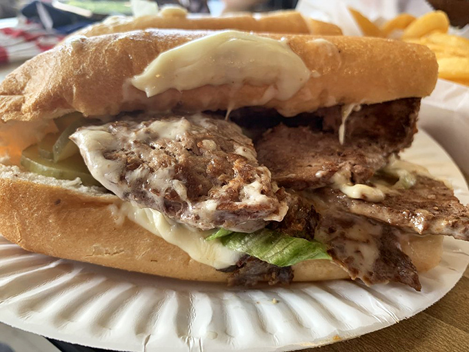 Behold the quintessential American cheeseburger—where melty cheese cascades over a properly seared patty with no unnecessary frills to distract from perfection.