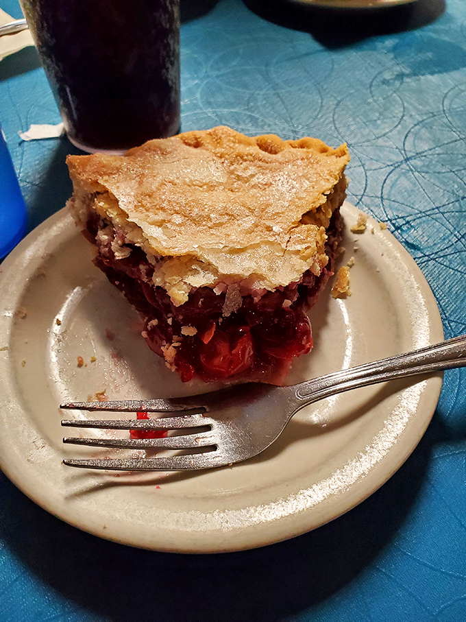 Cherry pie that strikes the perfect balance between sweet and tart, with a golden crust that shatters just right. The fork marks tell the real story – resistance is futile.