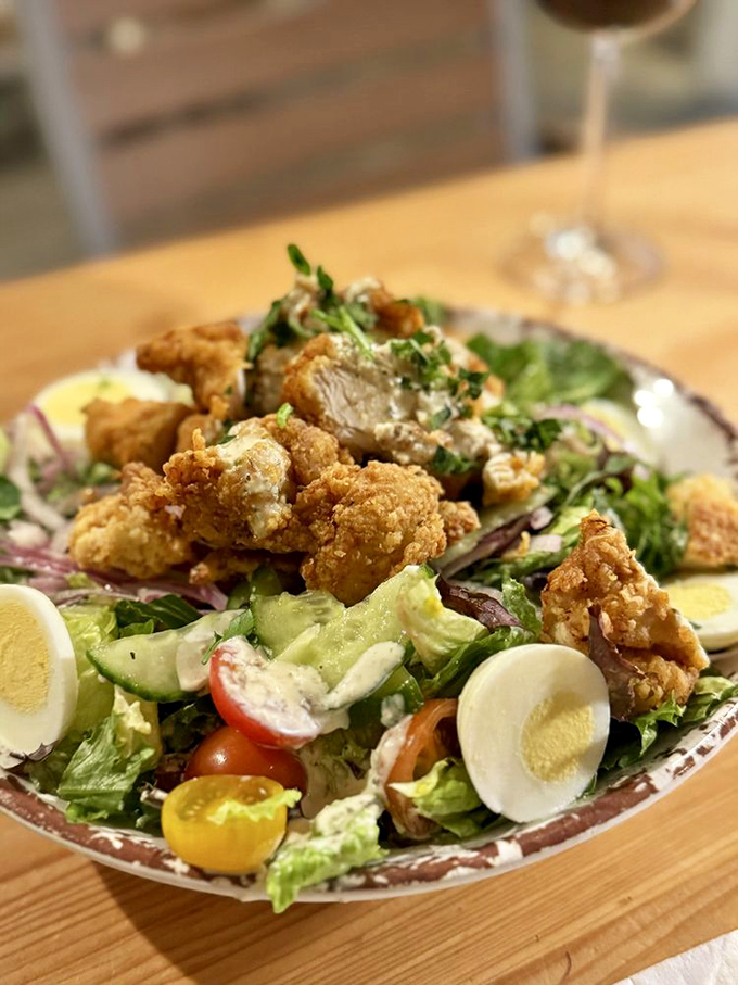 A salad that makes eating greens feel like cheating. Crispy fried chicken chunks transform ordinary lettuce into something worth Instagramming.