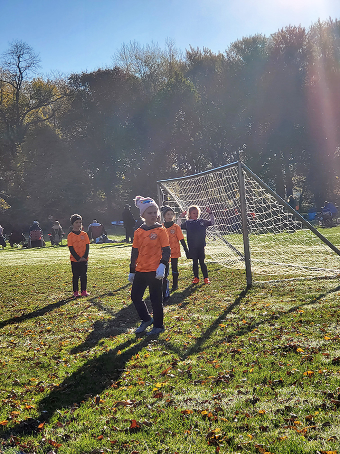 Youth soccer at its finest—where scoring goals takes second place to mastering the art of post-game snack negotiation.