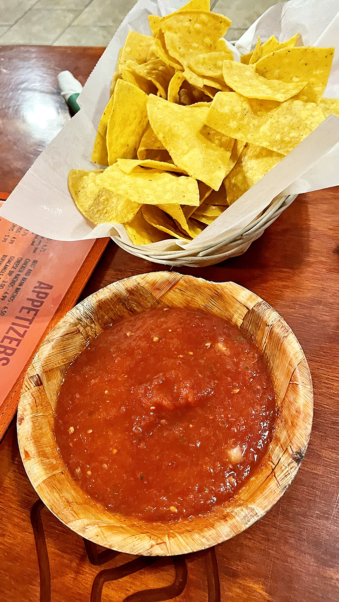 Chips and salsa—the opening act that sometimes steals the whole show. That wooden salsa bowl adds just the right touch of rustic charm.