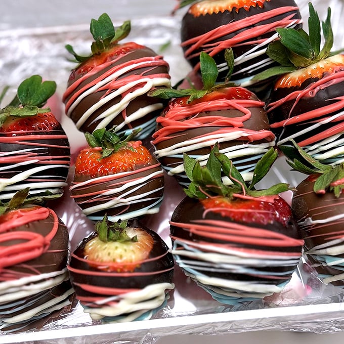 Strawberries playing dress-up in their chocolate finest. These berries didn't just get dipped—they got the full red-carpet treatment with those elegant drizzles.