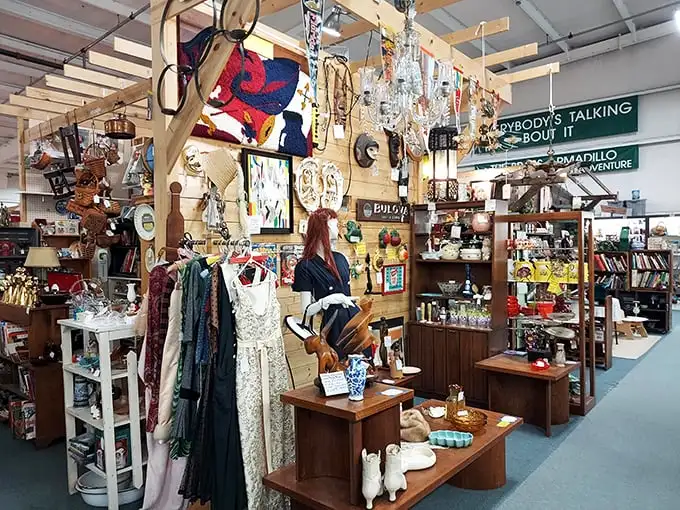 Vintage clothing hangs alongside chandeliers and curiosities—a fashion time machine where style never truly expires, it just waits to be rediscovered. 