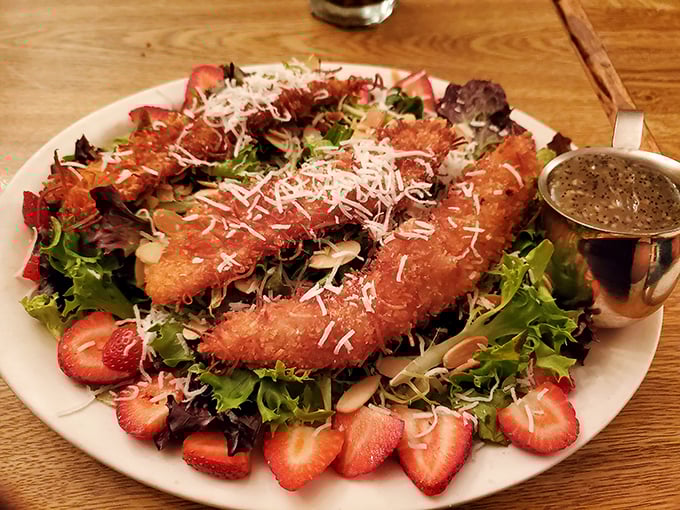 A salad that doesn't apologize for being delicious. Those coconut-crusted delights nestled among fresh strawberries prove salads don't have to be punishment.