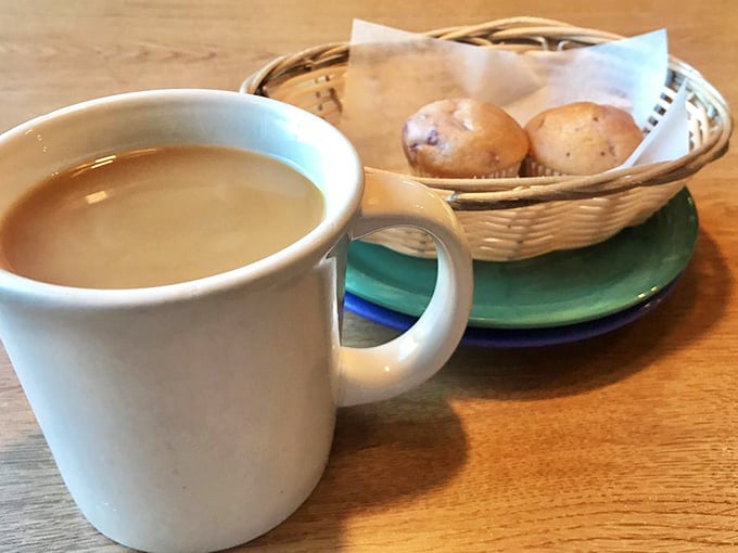 The classic diner mug—keeping America caffeinated since forever—paired with homemade muffins that whisper, "One more bite won't hurt."