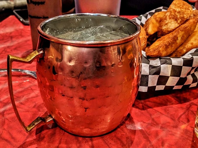 That copper mug isn't just holding a drink—it's cradling liquid refreshment that perfectly cuts through the richness of everything else on your table.