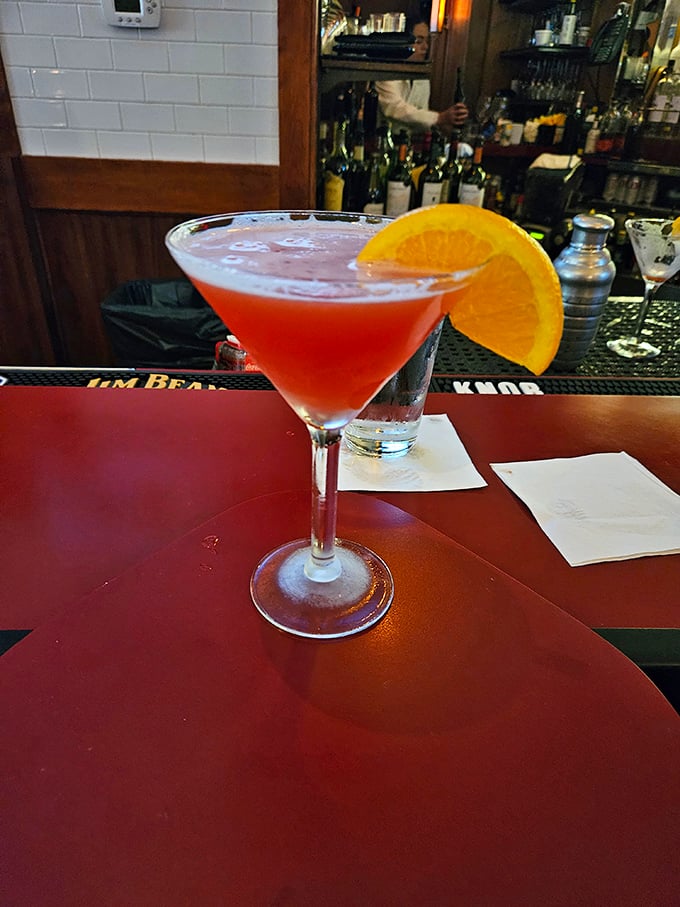 A cocktail so photogenic it deserves its own Instagram account, with that orange slice adding a pop of color like a sunset over Lake Michigan.