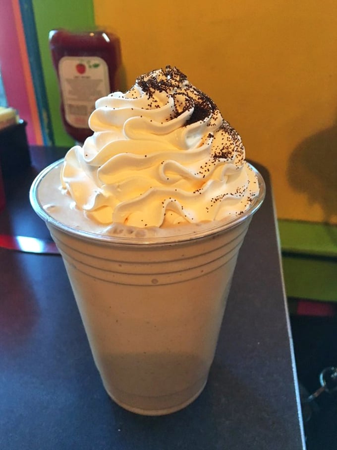 The milkshake that launched a thousand road trips—topped with whipped cream and what appears to be cookie crumbles, it's dessert masquerading as a beverage.