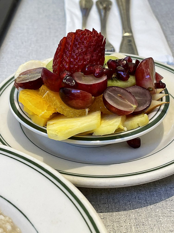 A fruit bowl that actually looks like someone cares—vibrant strawberries, grapes, and pineapple that weren't just scooped from a plastic tub.