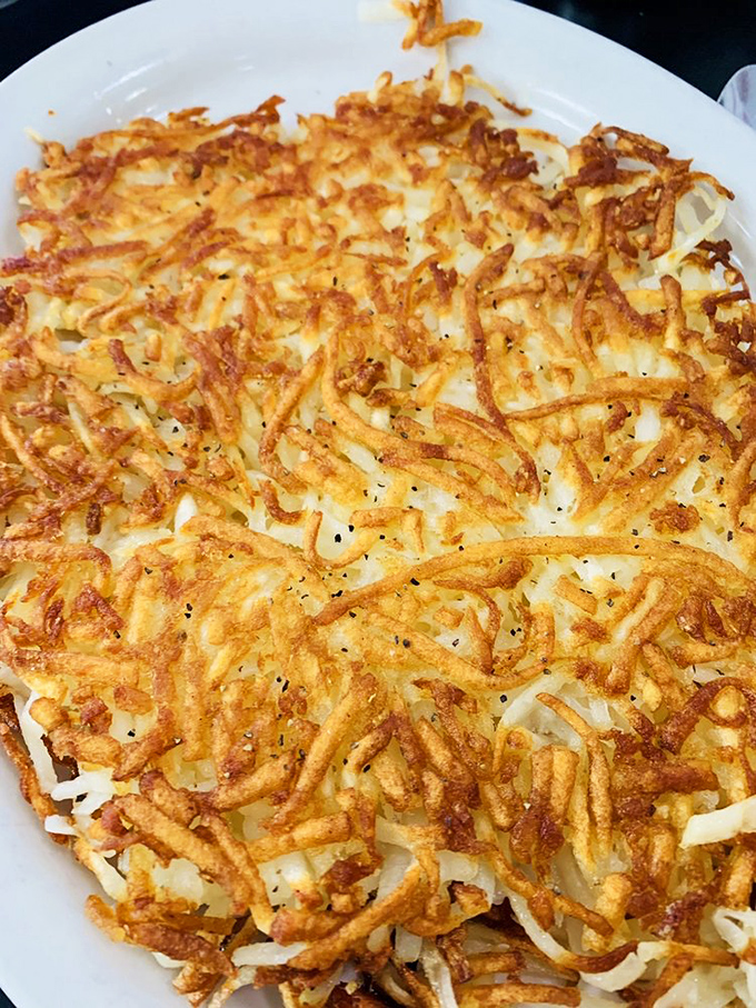 These hash browns deserve their own zip code – a crispy, golden landscape of potato perfection that puts all other breakfast sides to shame.