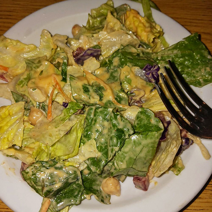This isn't just a salad—it's the supporting actor that deserves its own award, bringing crunch and freshness to balance the meaty main event.