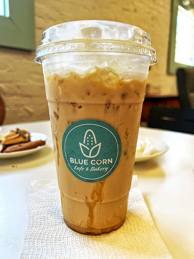 That iced caramel latte isn't just a drink—it's a portable moment of caffeinated bliss, complete with the cafe's signature turquoise logo.