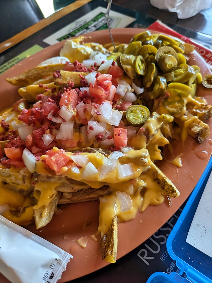 Loaded River Fries—where potatoes meet their destiny under an avalanche of cheese, bacon, and veggies. Fork required, sharing optional.