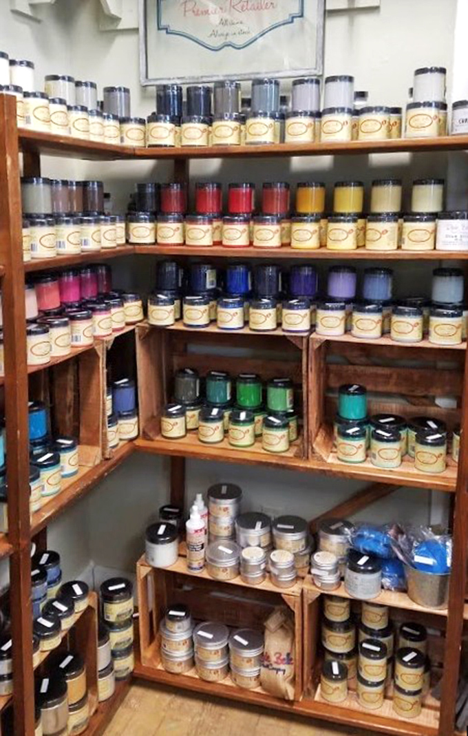 A rainbow of possibilities lines these shelves—each jar containing someone's next creative project or the perfect shade for restoring a mid-century treasure.