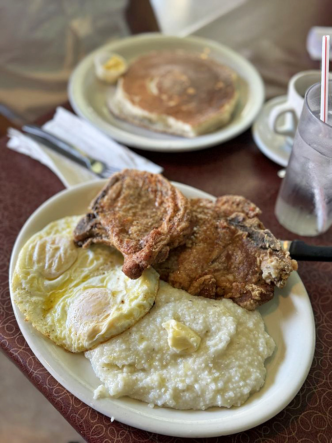 Pork chops cooked to perfection alongside creamy grits and sunny-side-up eggs – the breakfast equivalent of winning the lottery.