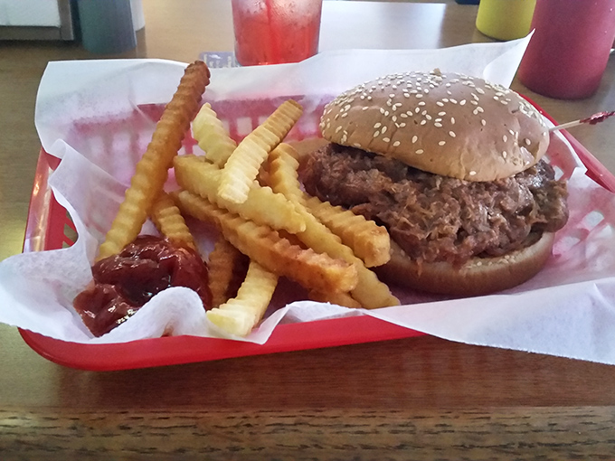 Not all heroes wear capes—some come on sesame seed buns. This pulled pork masterpiece with crispy fries makes Monday feel like Saturday.